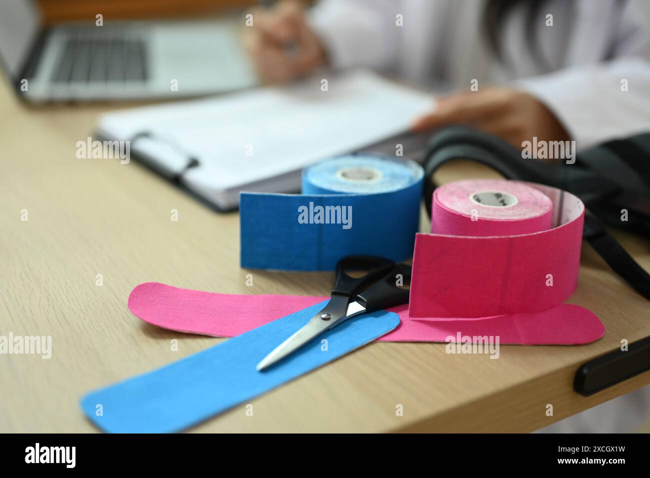 Kinesio tapes and scissors on table at physiotherapist office ...