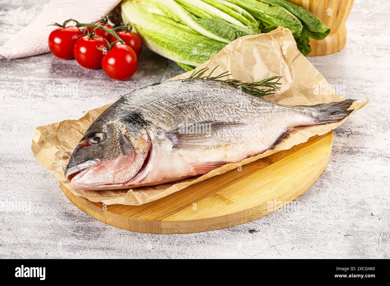 Raw dorada fish served rosemary for cooking Stock Photo - Alamy
