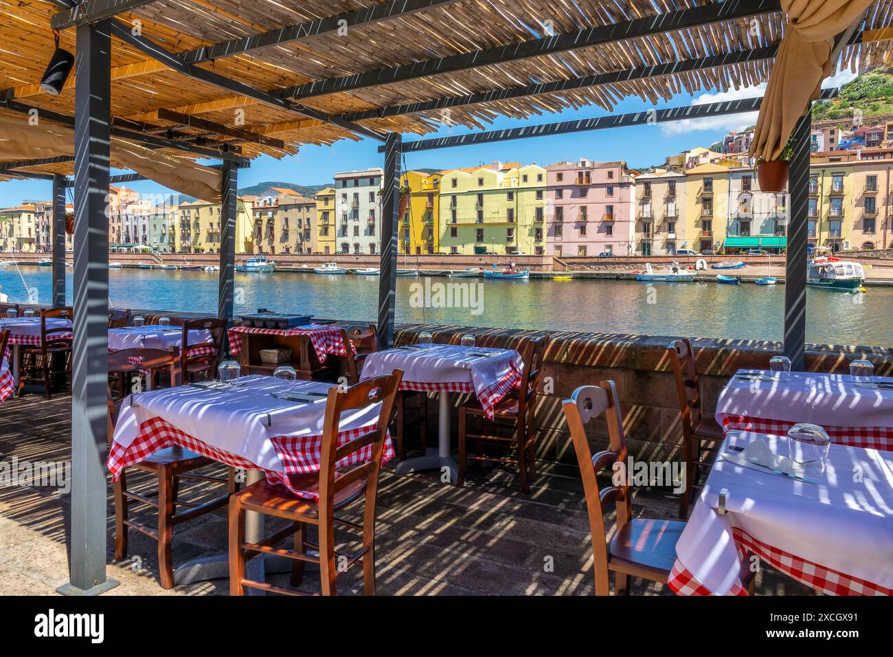 Outdoor terrace of an Italian restaurant with a view on the river and ...