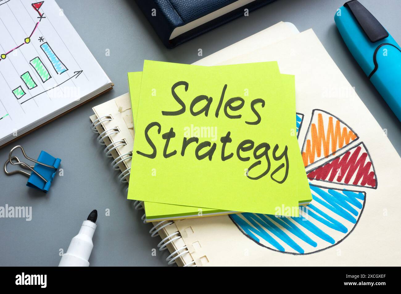 Sales strategy in notepad with charts and graphs Stock Photo - Alamy