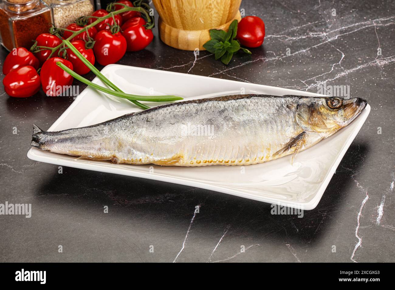 Whole raw salted herring fish in the plate Stock Photo - Alamy