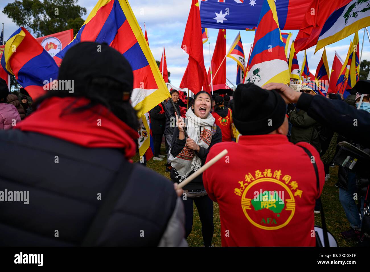 A protester from the Tibetan community seen waving the Tibetan flag ...
