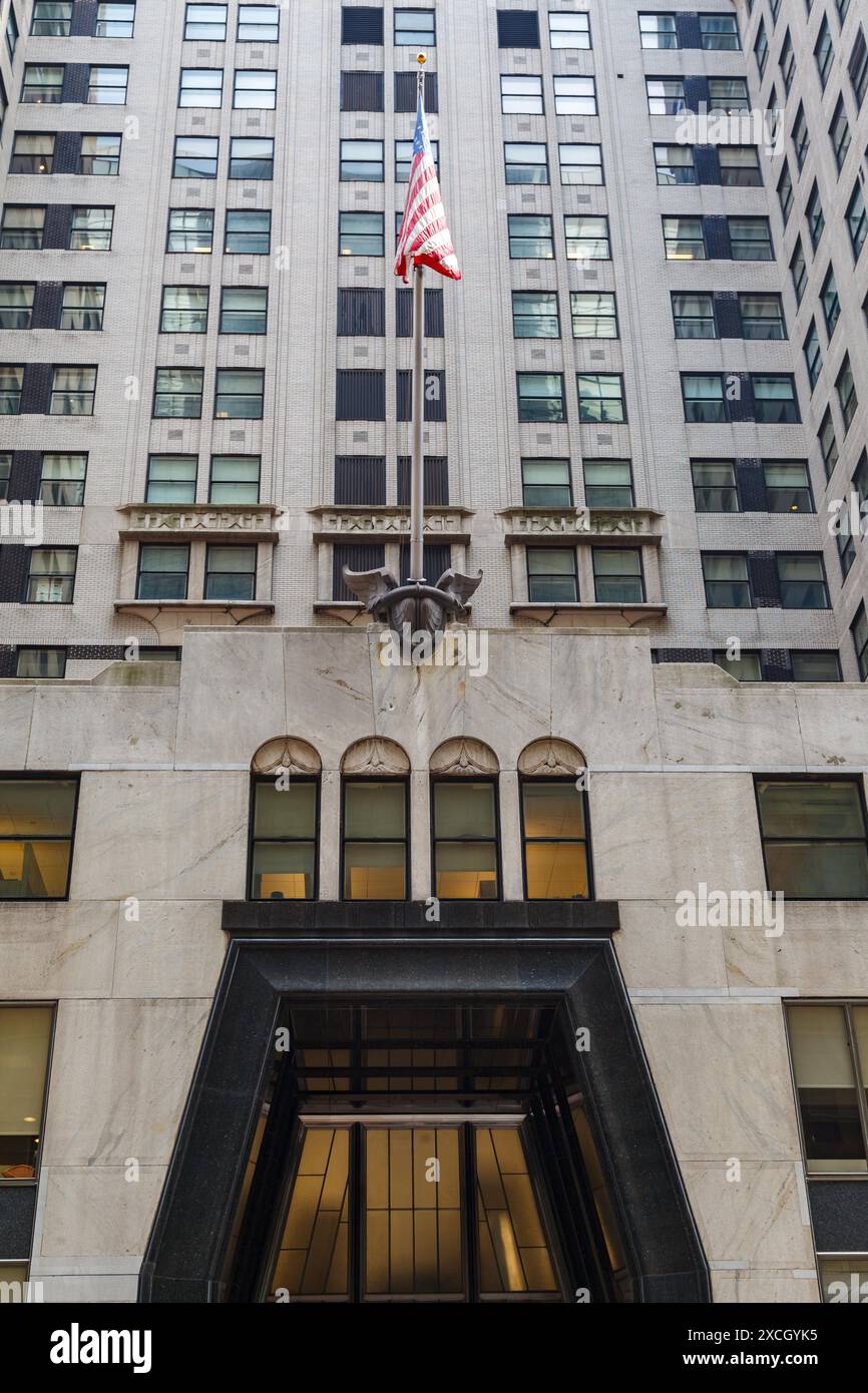 The facade of the iconic Chrysler building with the US flag waving ...