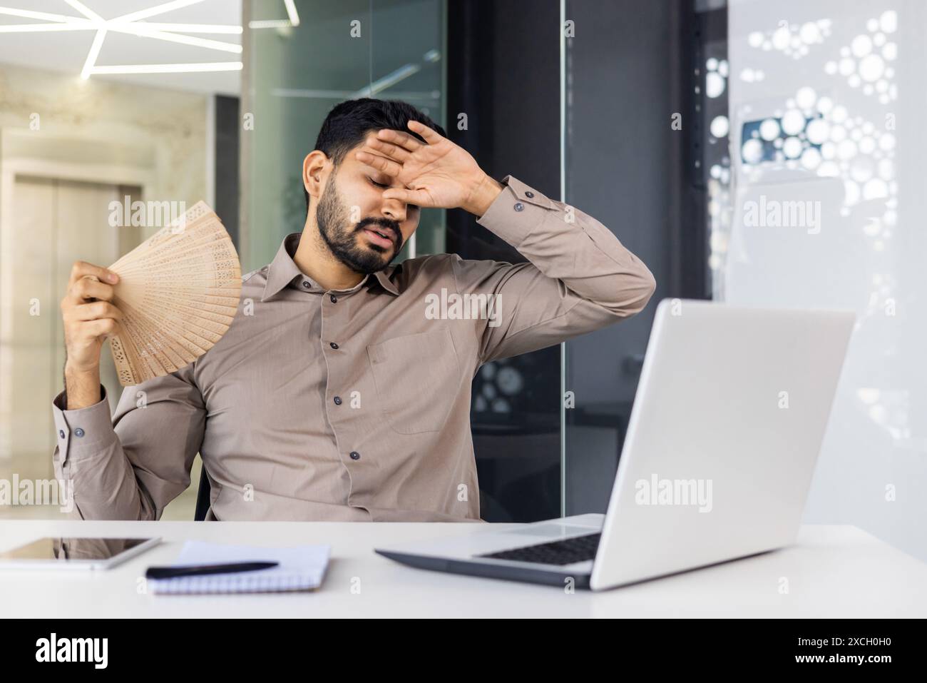 Man in office fanning hi-res stock photography and images - Alamy