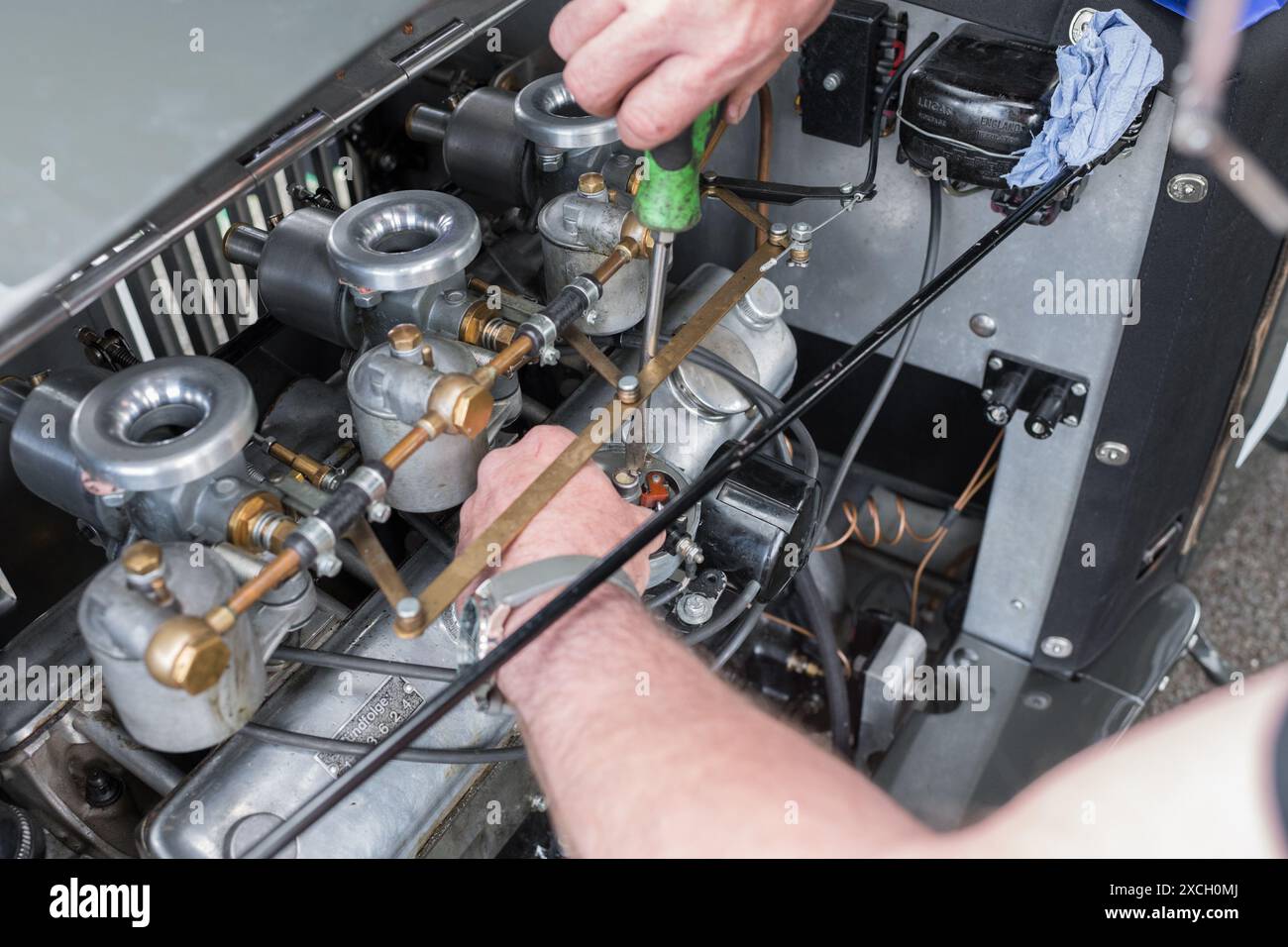 racing car mechanic working on and adjusting the electrical points in ...