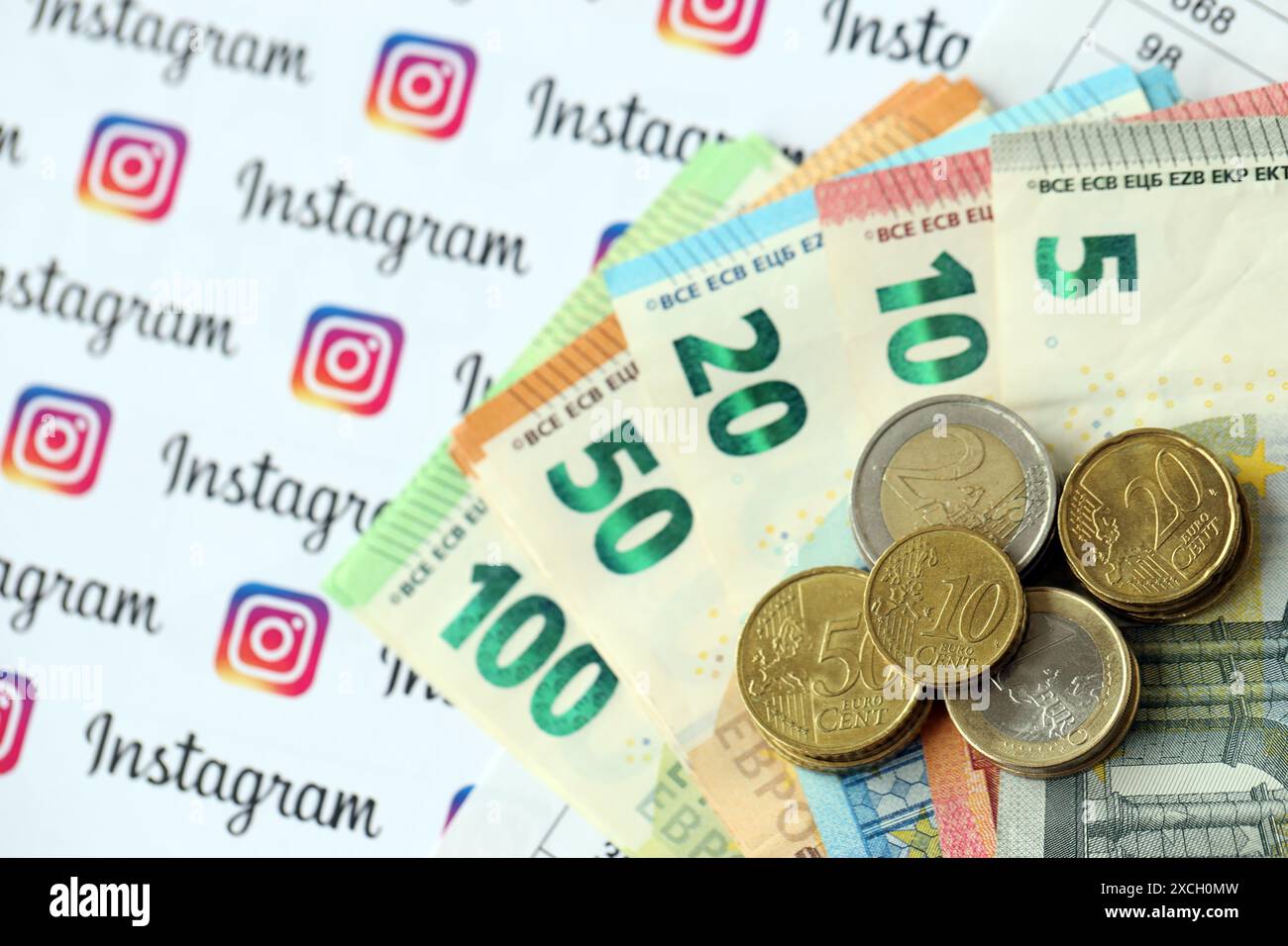 KYIV, UKRAINE - APRIL 20, 2024 Instagram logo and many euro money bills ...