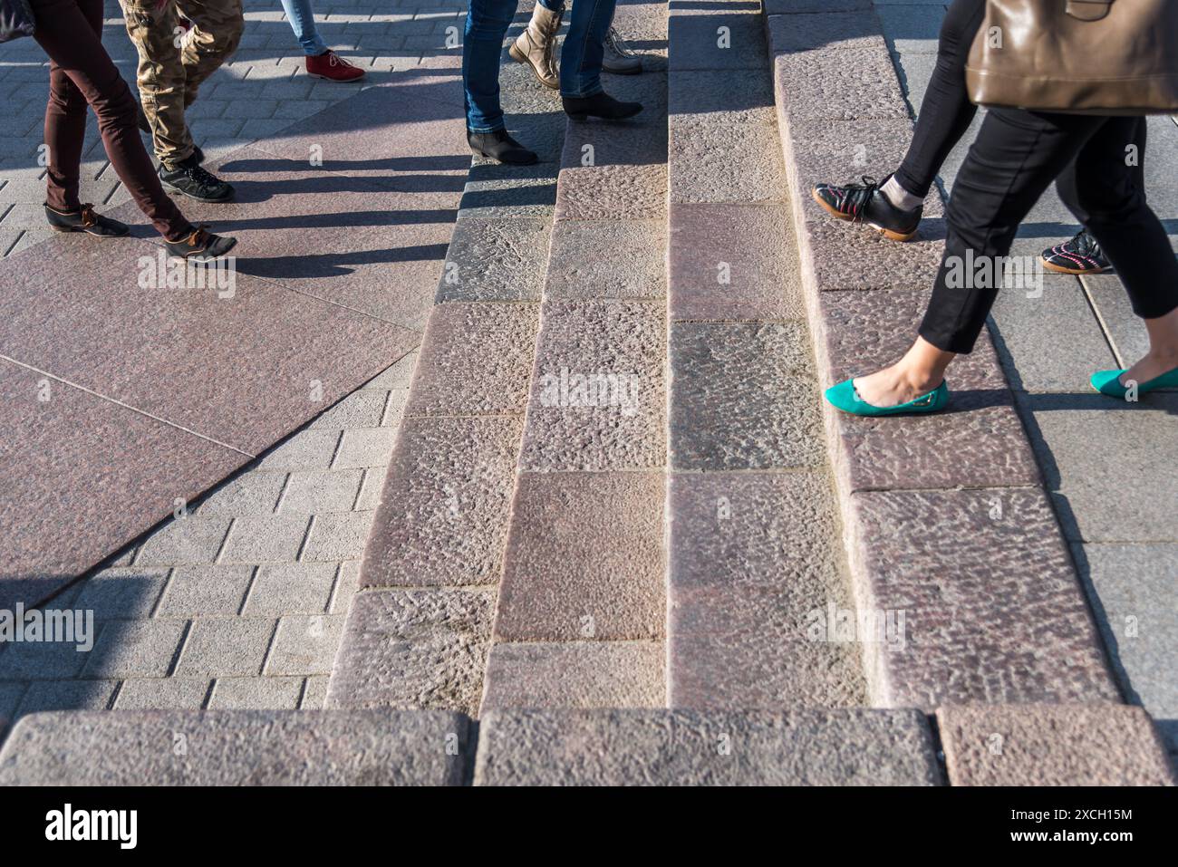 Many Legs Of Walking People By The Stairs In The City Square Stock ...