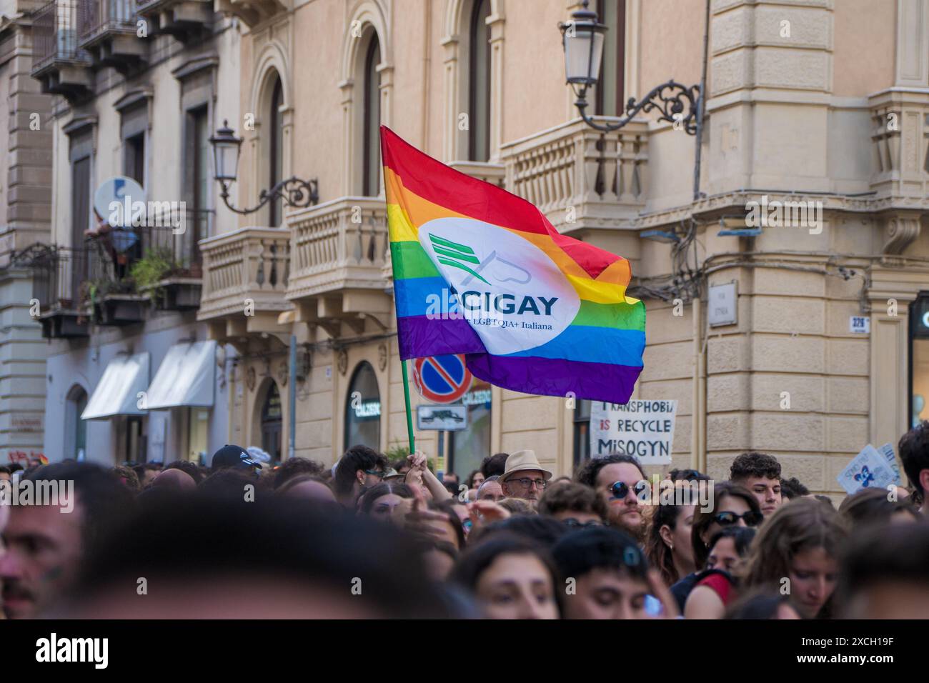 CATANIA, ITALY - JUNE 15, 2024: A rainbow flag waves proudly among the crowd during the Gay ...