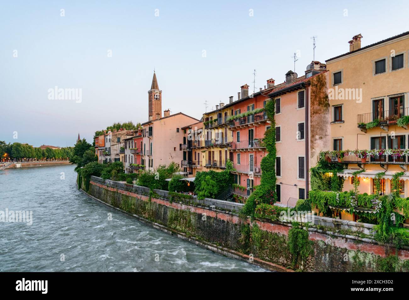 Scenic facades of old houses decorated with plants on waterfront of the ...