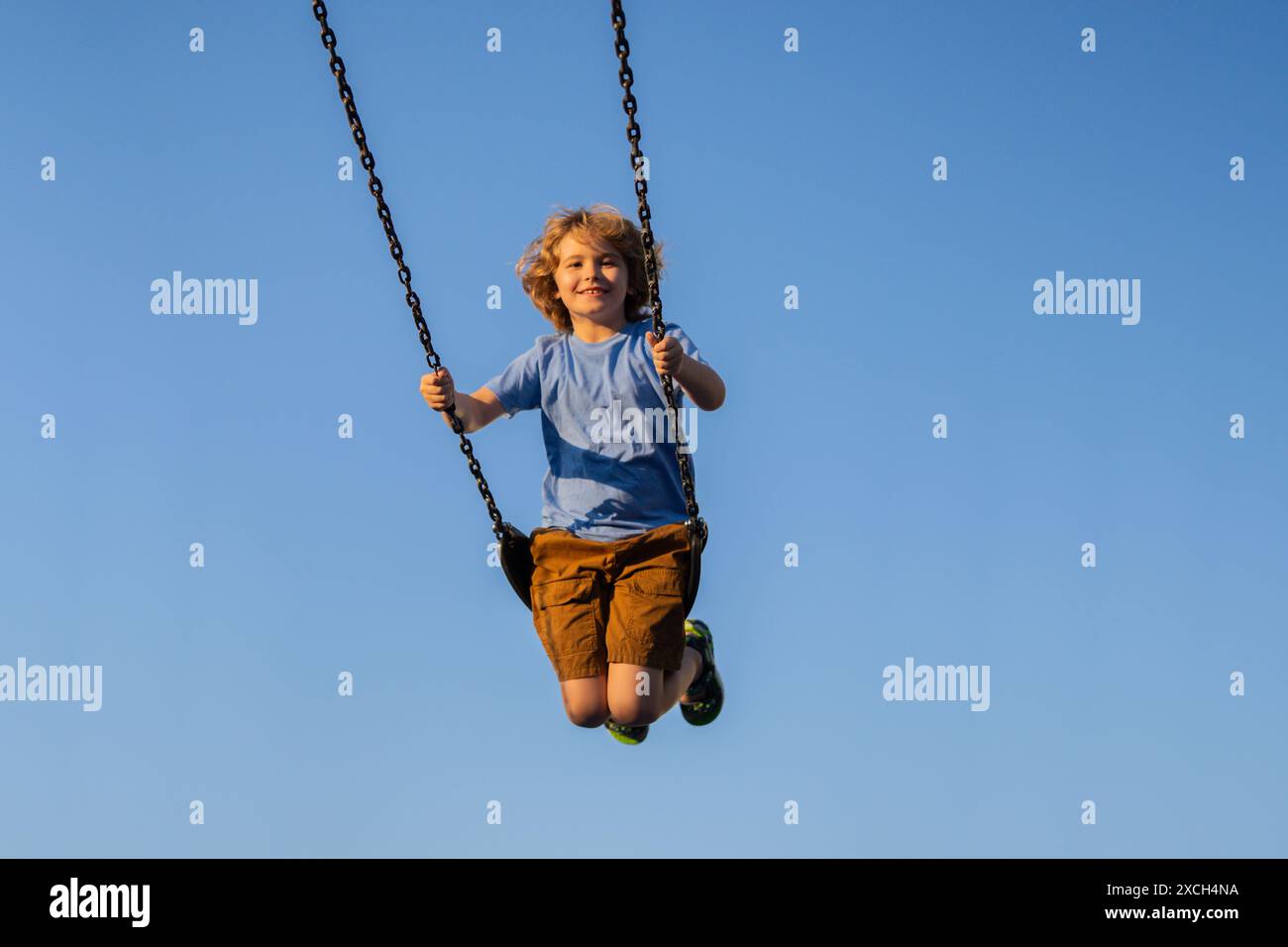 Child extreme swinging. Danger high Swing in sky. Cute child having fun ...