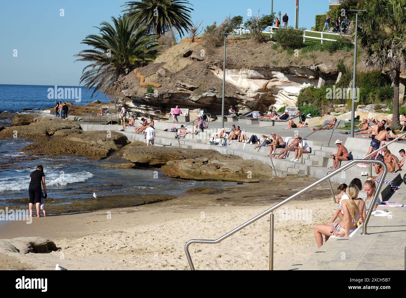 People, locals sunbathing on the concrete platform and steps at South ...