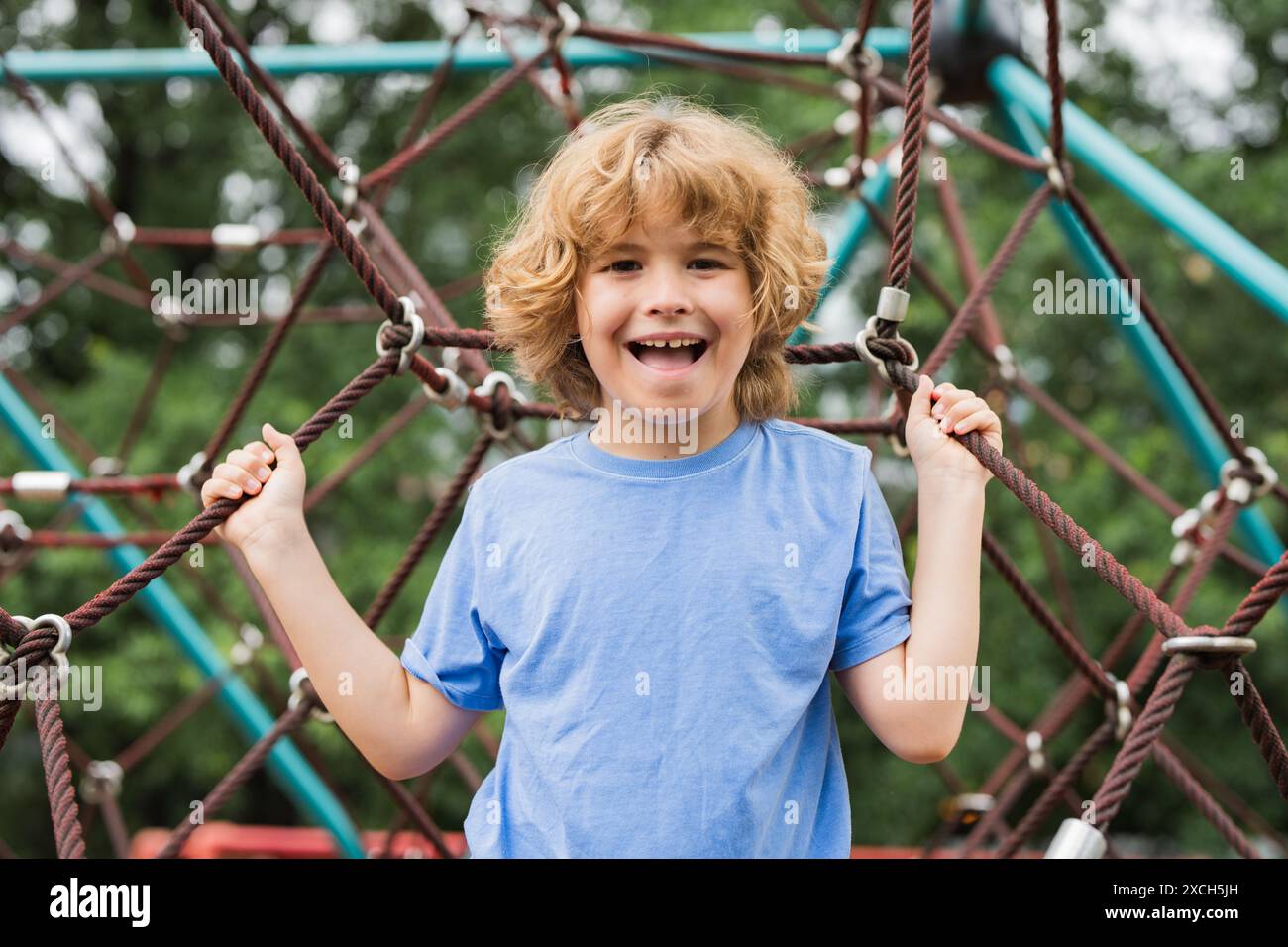 The outdoor playground for children in summer park. Kid play on ...