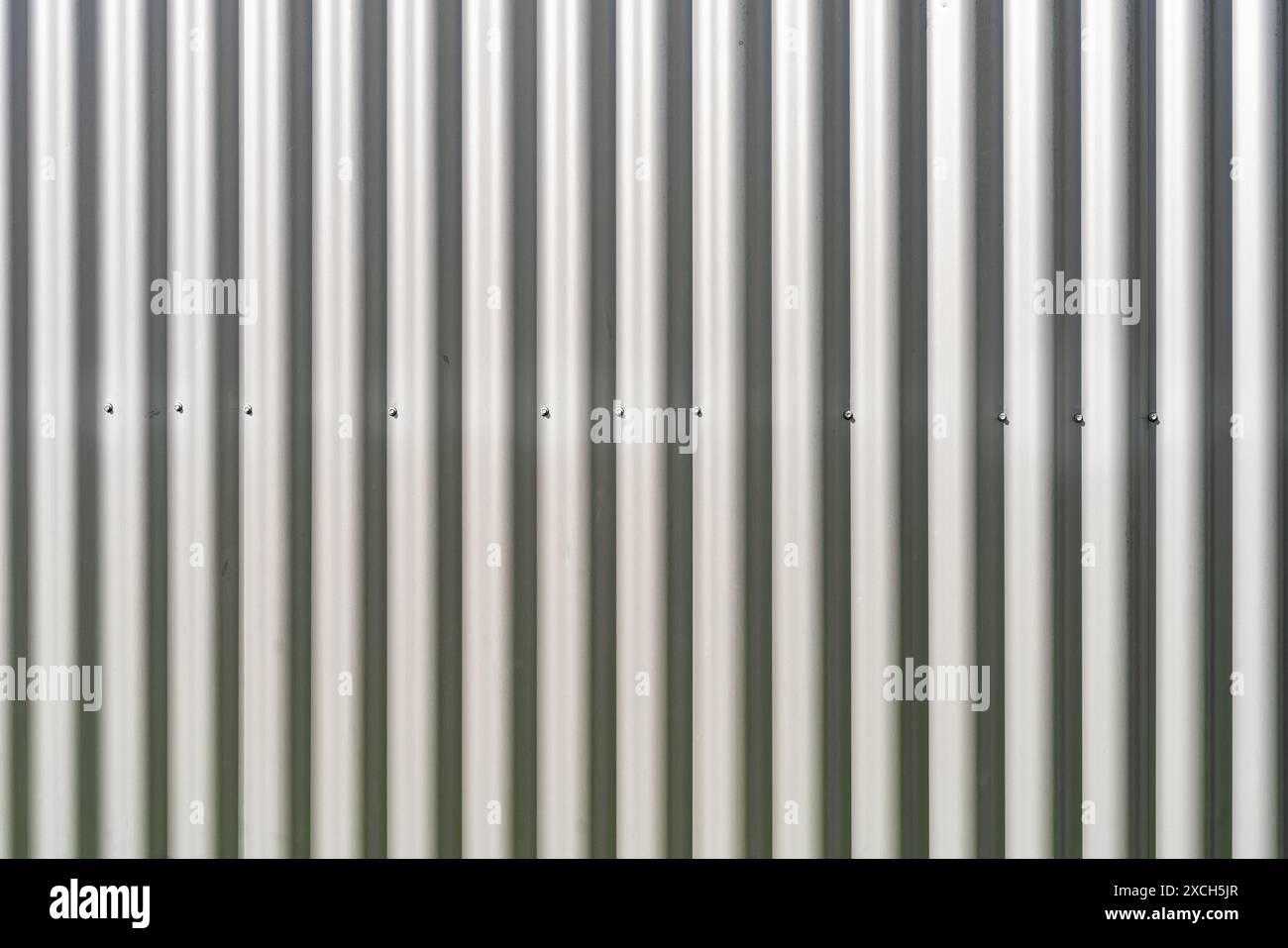 Corrugated metallic cover sheets, attatched with bolts to an industrial ...