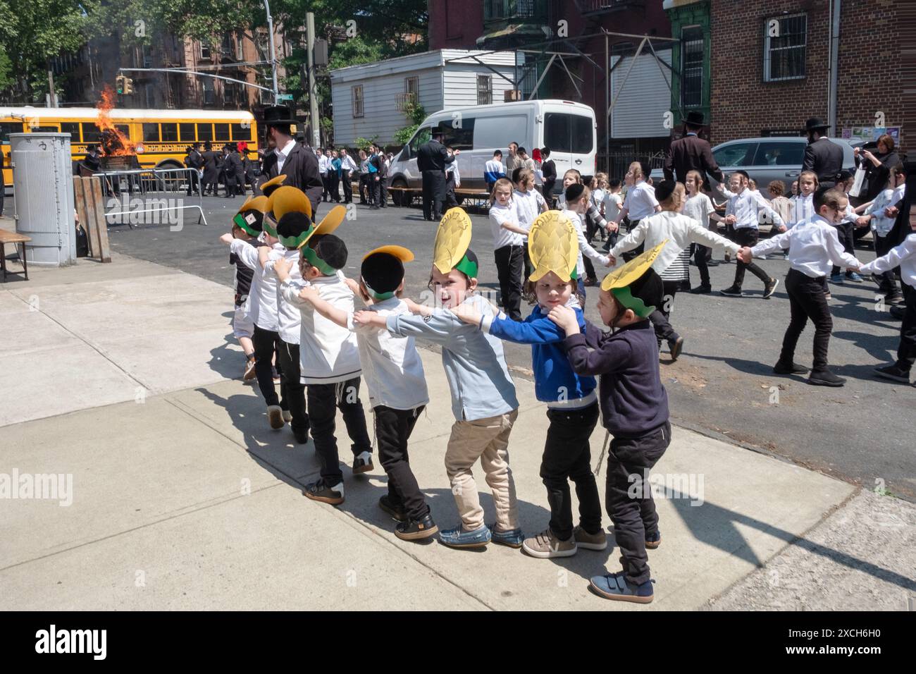 Lag B'Omer celebration at a yeshiva with a traditional fire & with special Lag B'Omer hats, In ...