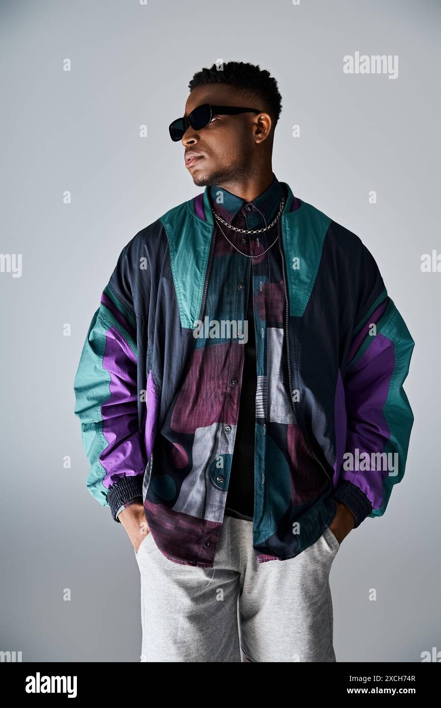 Young handsome man in vibrant jacket and shades, exuding style Stock ...