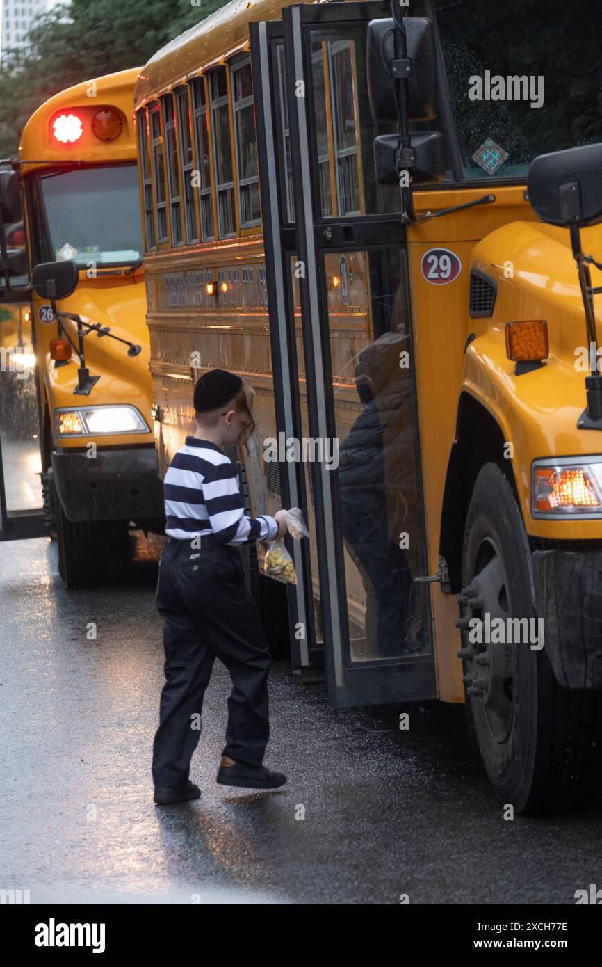 On a drizzly morning 2 two ultra orthodox Jewish boys boards a bus to ...