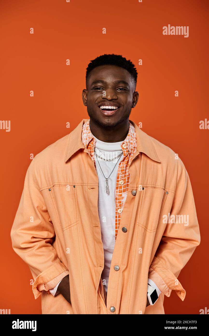 Handsome man in orange jacket and white shirt Stock Photo - Alamy