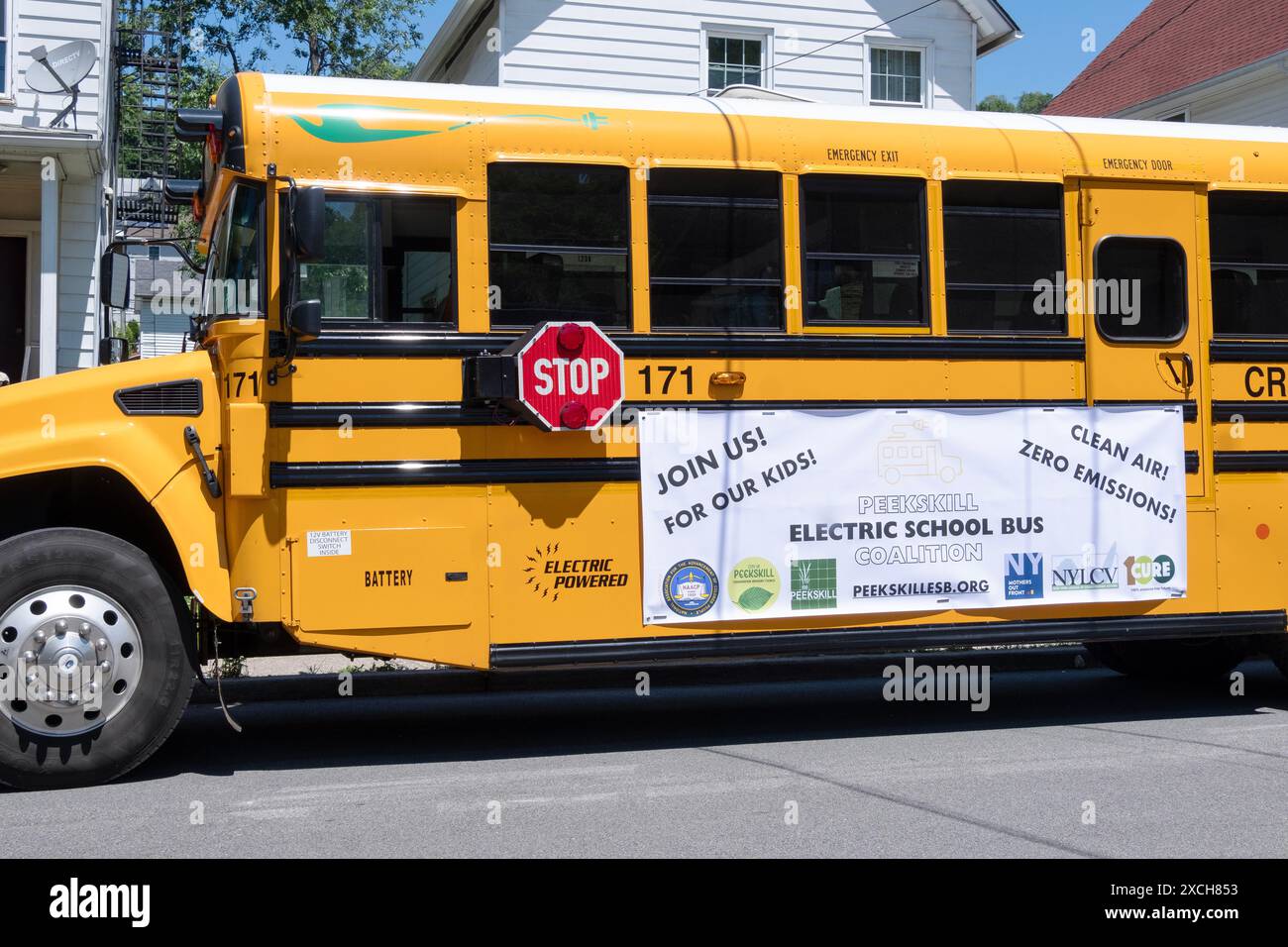 A banner on the side of an electric Peekskill school bus advocating for ...