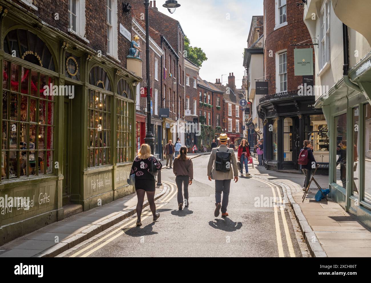 People walk past shops and stores in High Petergate in the historic ...