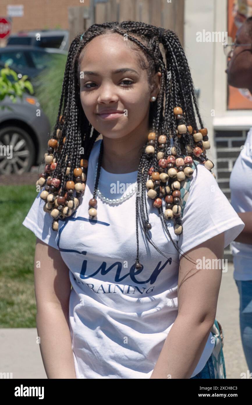 A beautiful young lady with long cornrows decorated with beads. At the ...