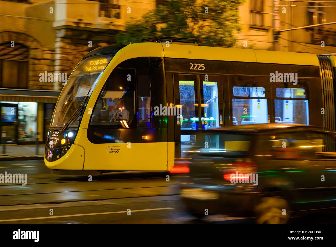A CAF Urbos 3 tram on a rainy evening at night in Budapest, Hungary ...