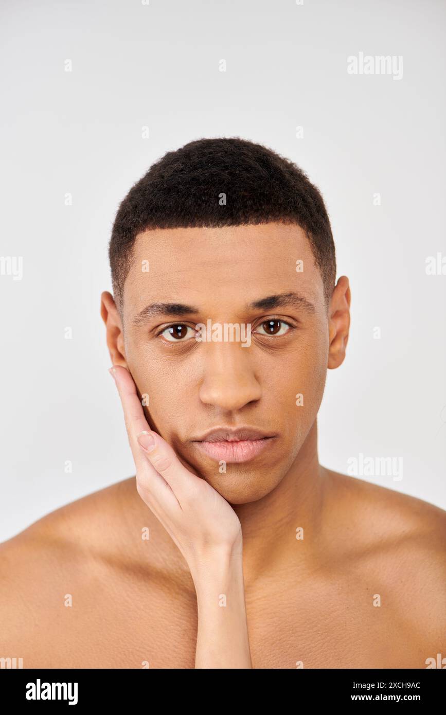 Young man deep in thought, womans hand on face Stock Photo - Alamy