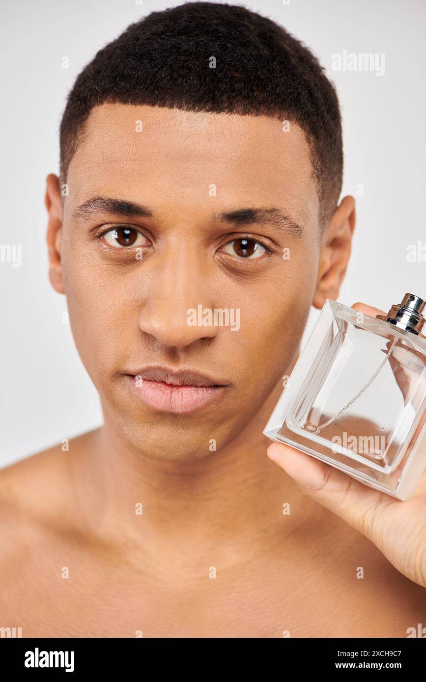 Young man holds bottle hi-res stock photography and images - Alamy