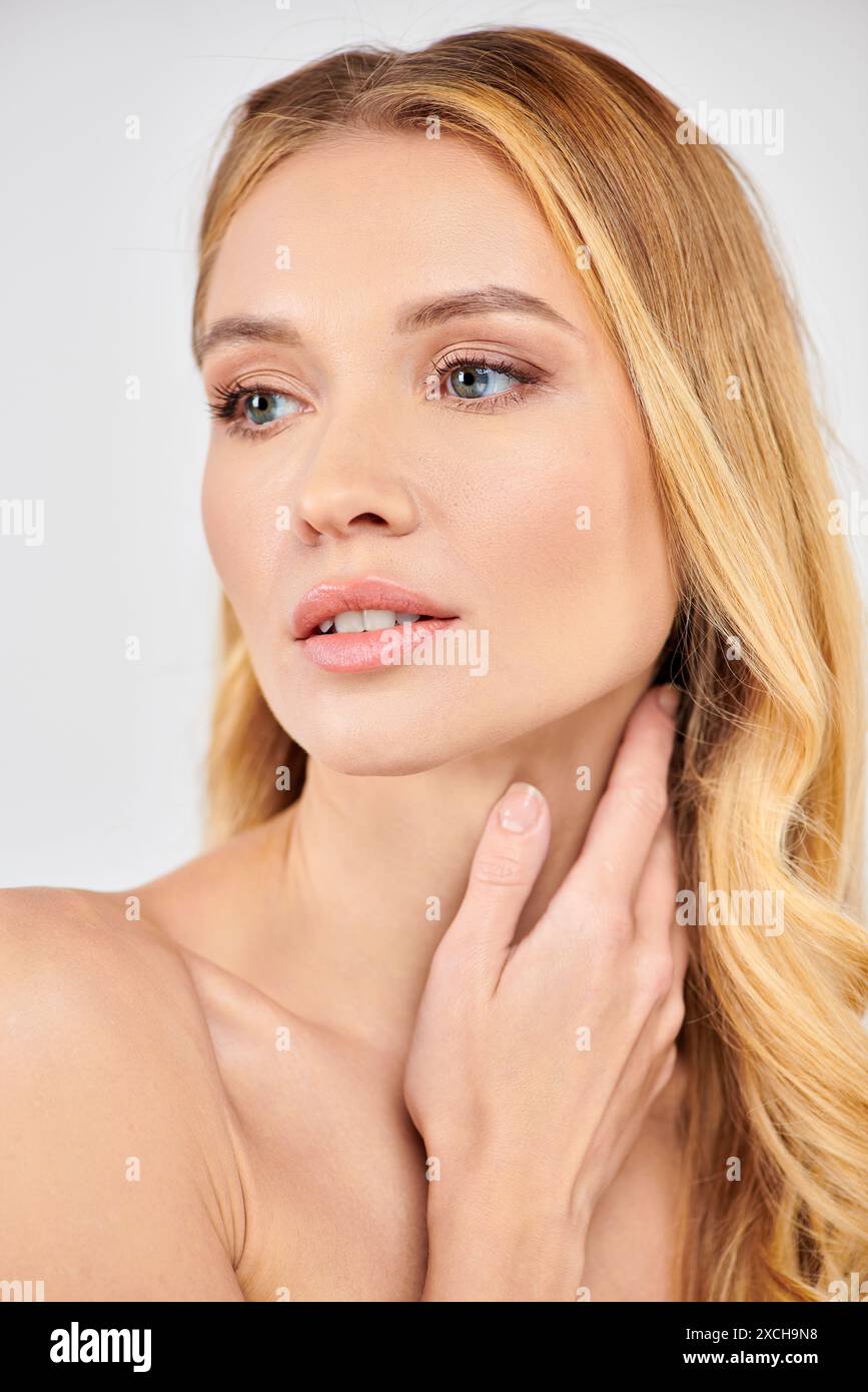 Woman standing peacefully, hands on neck Stock Photo - Alamy
