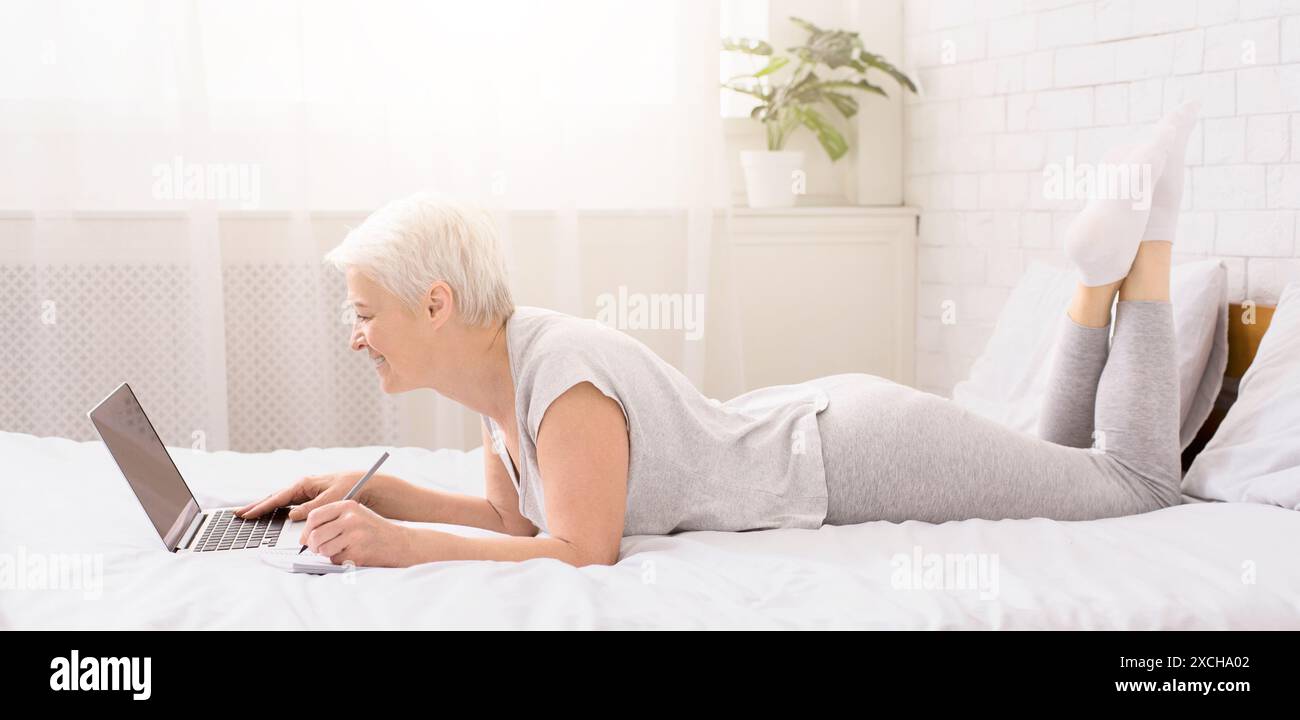 Woman Laying on Bed Using Laptop Computer, Make Research Stock Photo ...