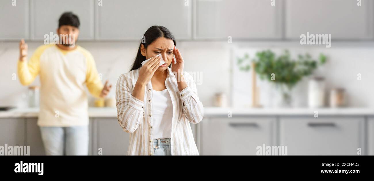 Woman Crying in Kitchen While Man Stands Behind Her Stock Photo - Alamy