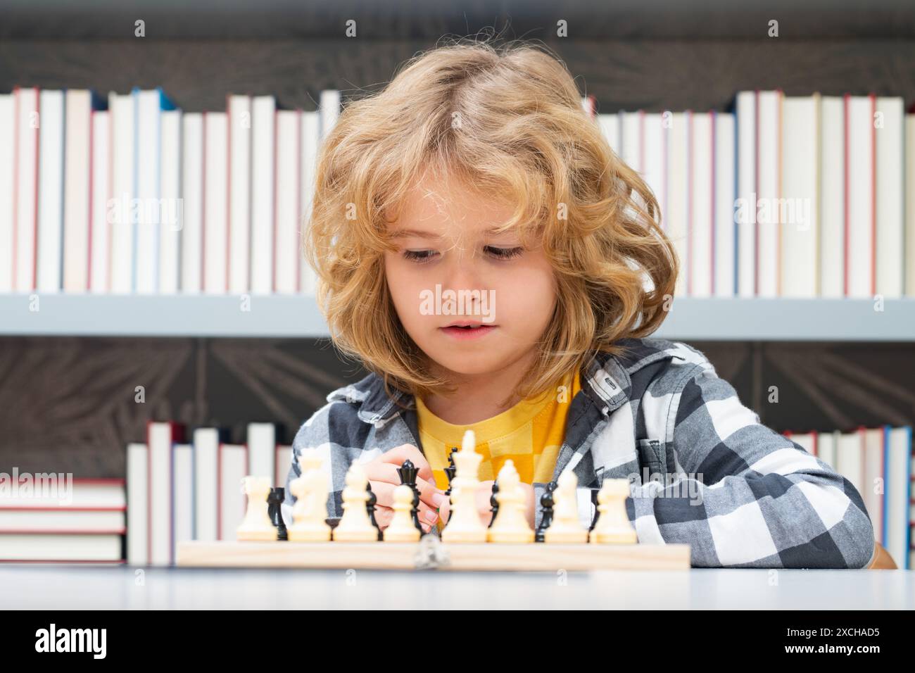 Kid play chess in classroom at school. Kid playing chess. Child ...