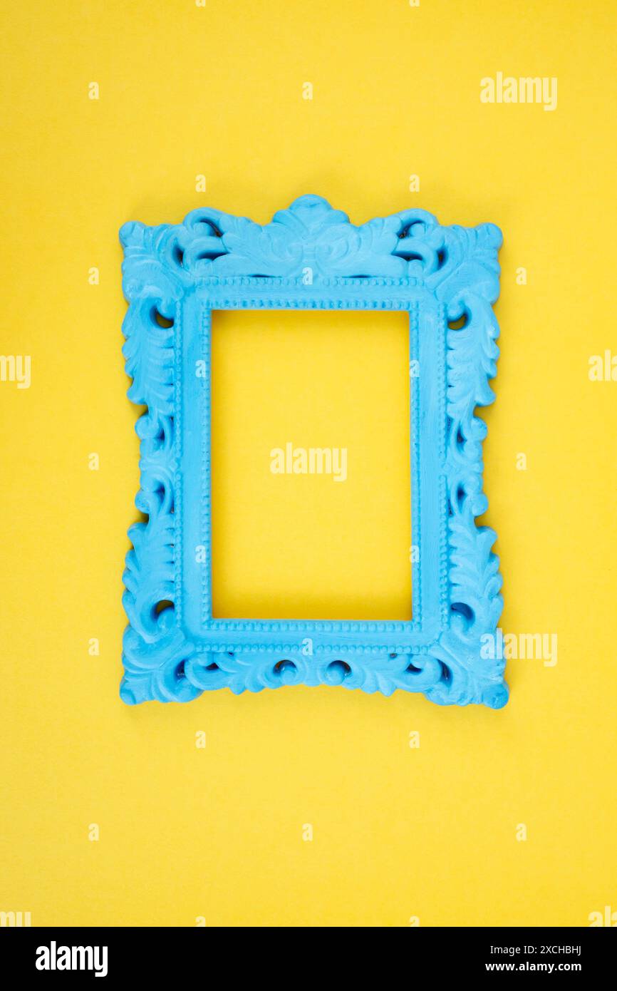 Blue painted baroque frame on yellow background Stock Photo - Alamy