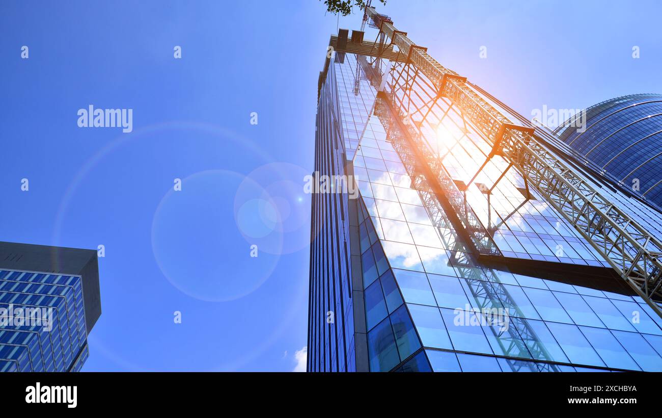 High rise building under construction. Installation of glass facade ...