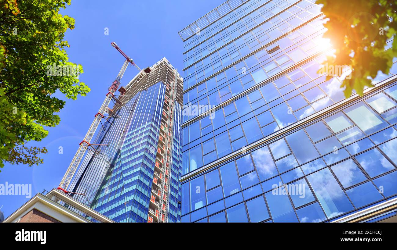 High rise building under construction. Installation of glass facade ...