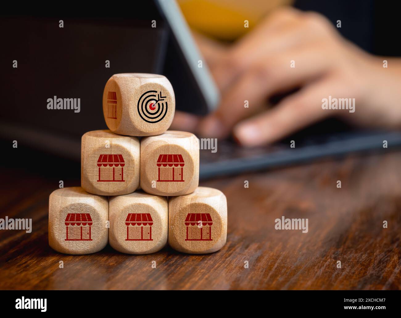 Target icon and business store shop symbol on wooden cube blocks pyramid stack on table while ...