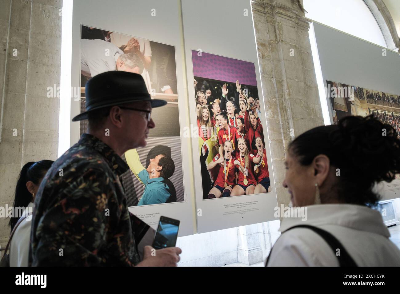 A group of visitors look at images during the inauguration of the ...