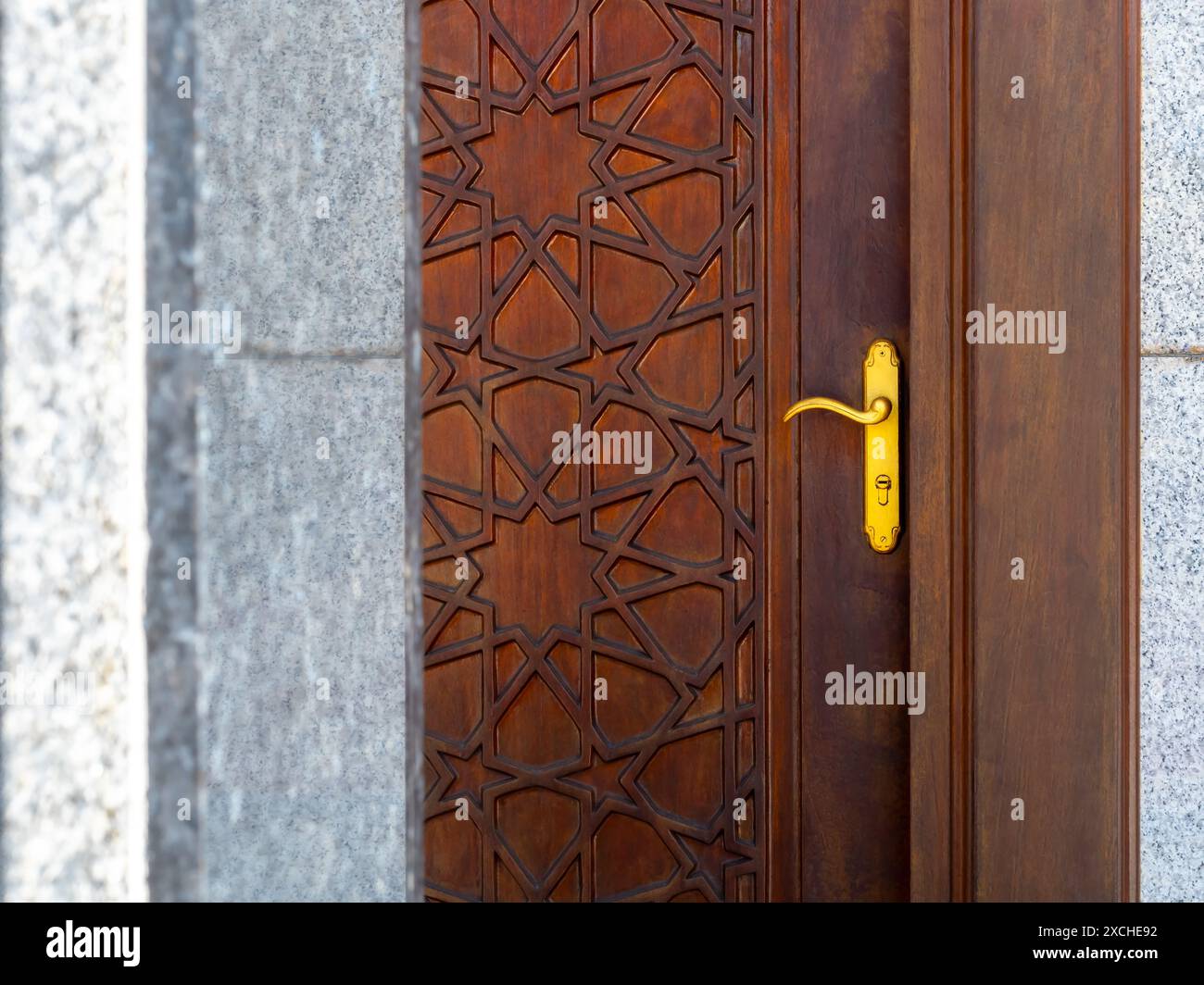 Beautiful pattern on curved wooden door with gold handle, decoration of ...