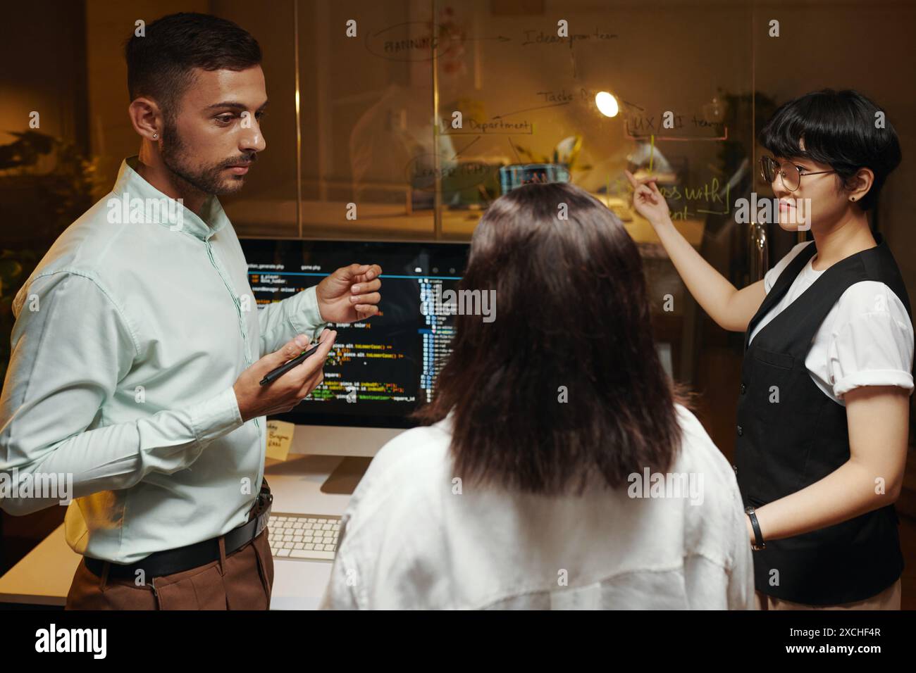 Multi-ethnic team discussing UI design in meeting Stock Photo - Alamy