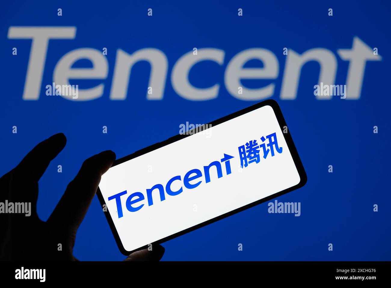 The Tencent logo is being displayed on a smartphone, with Tencent in ...