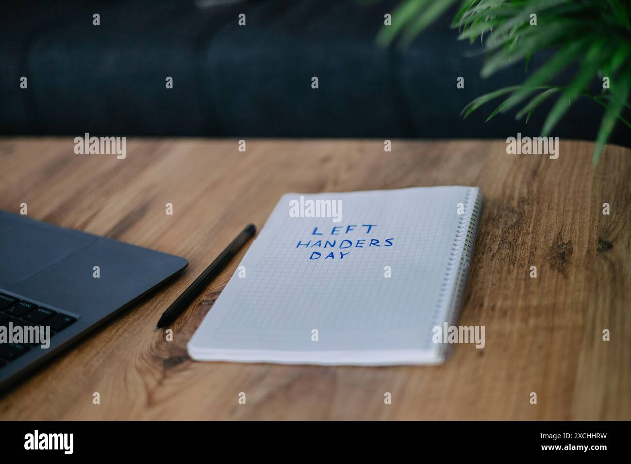 a notebook with a text Left handers day Stock Photo - Alamy