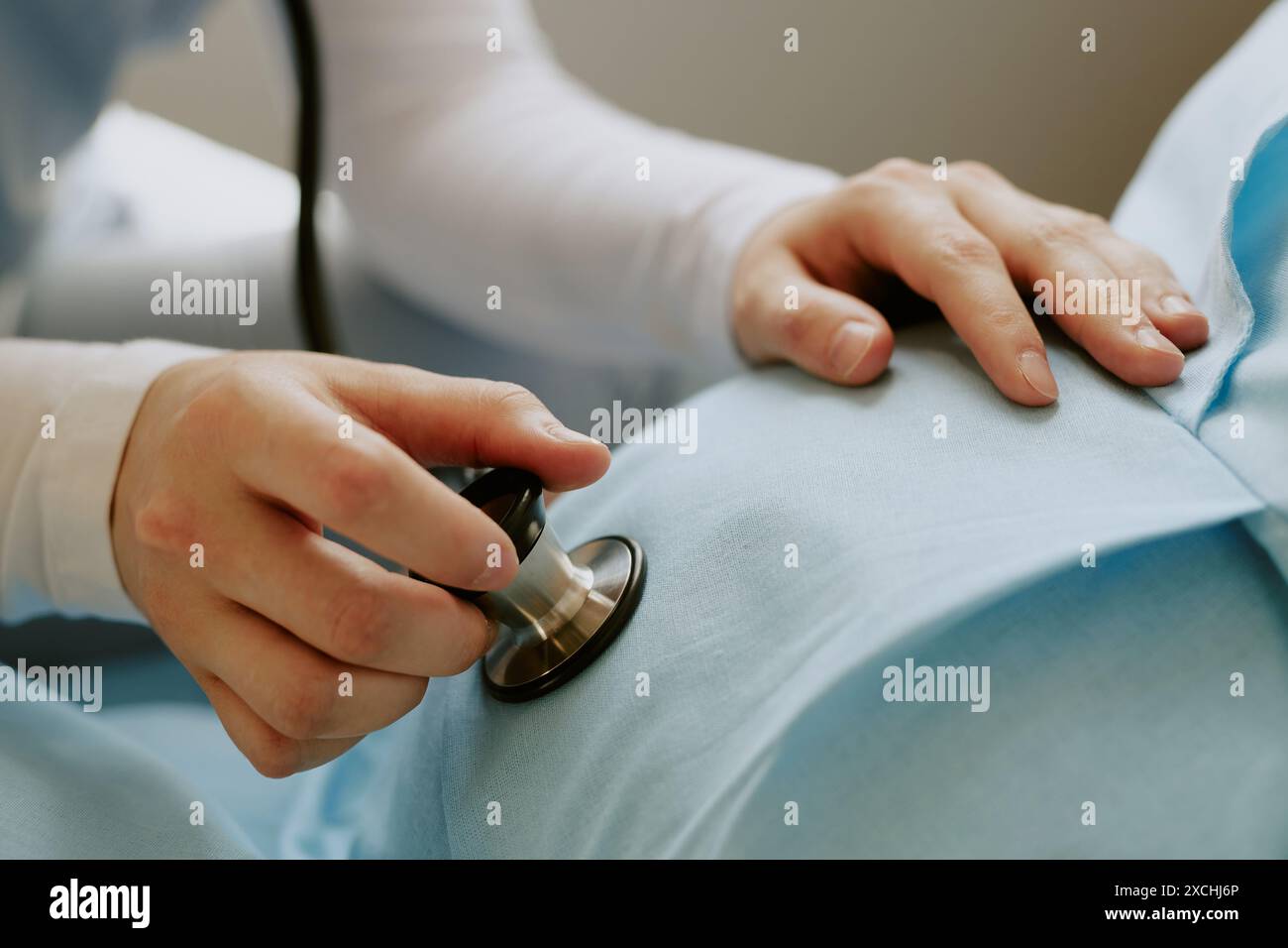 Medium close up of doctors hand holding stethoscope and touching ...