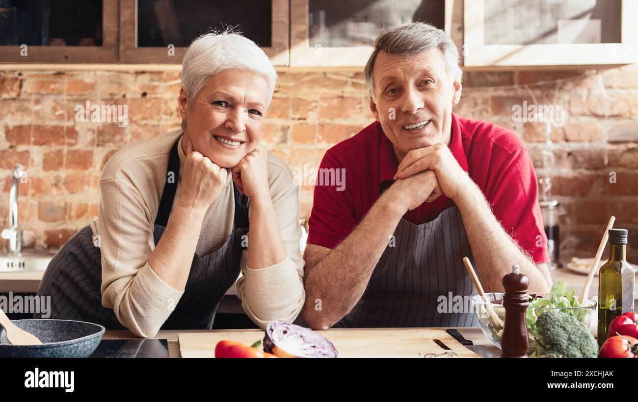 Positive Senior Couple Cooking Together In Modern Kitchen Stock Photo ...