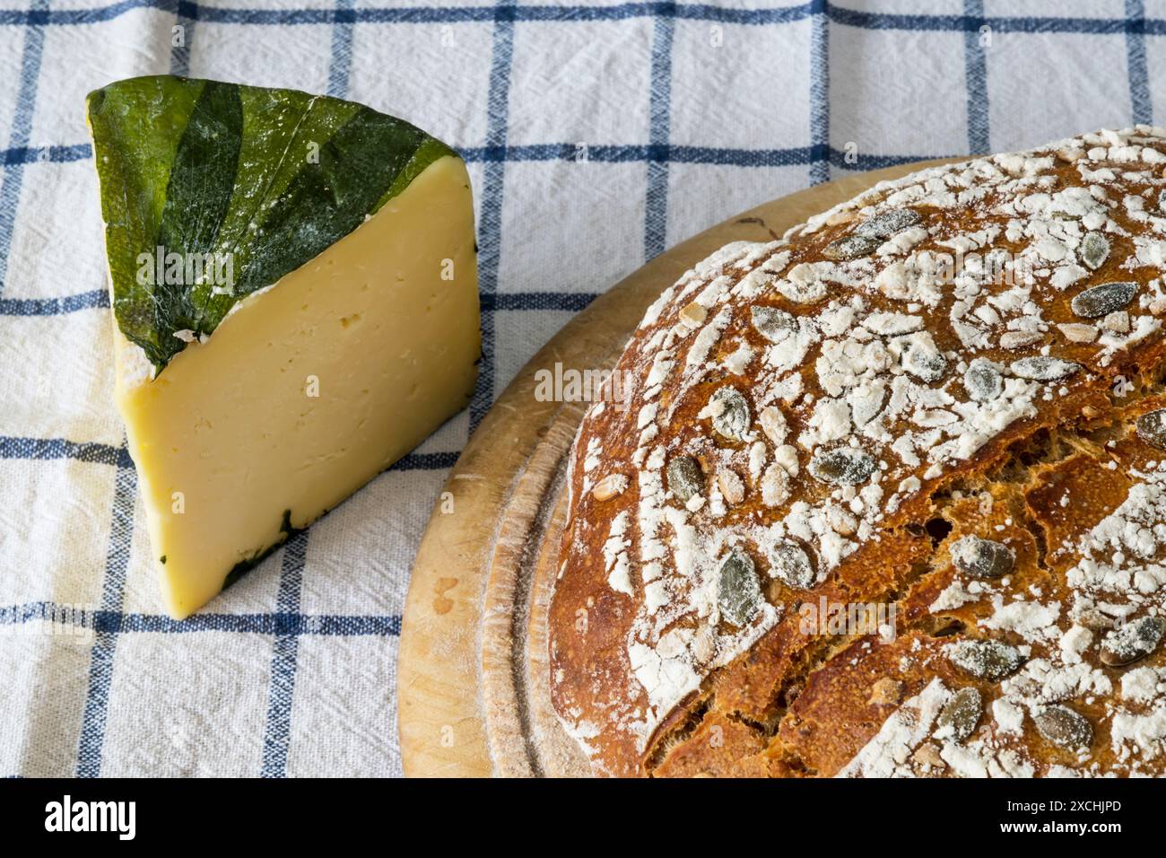 A piece of Cornish Yarg cheese with a loaf of homemade sourdough bread ...