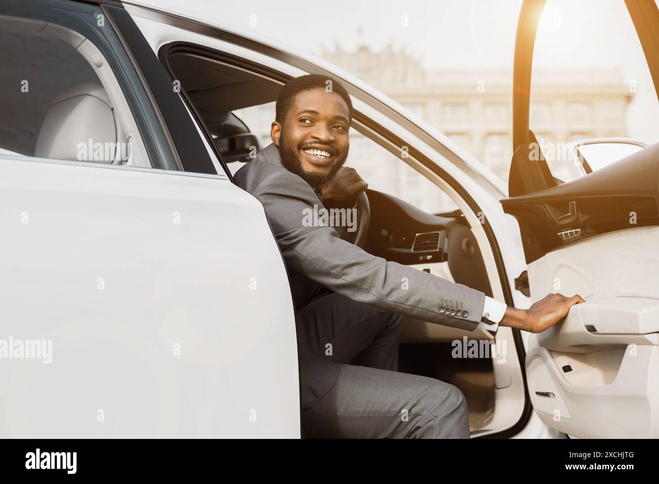 Suit black car exiting hi-res stock photography and images - Alamy