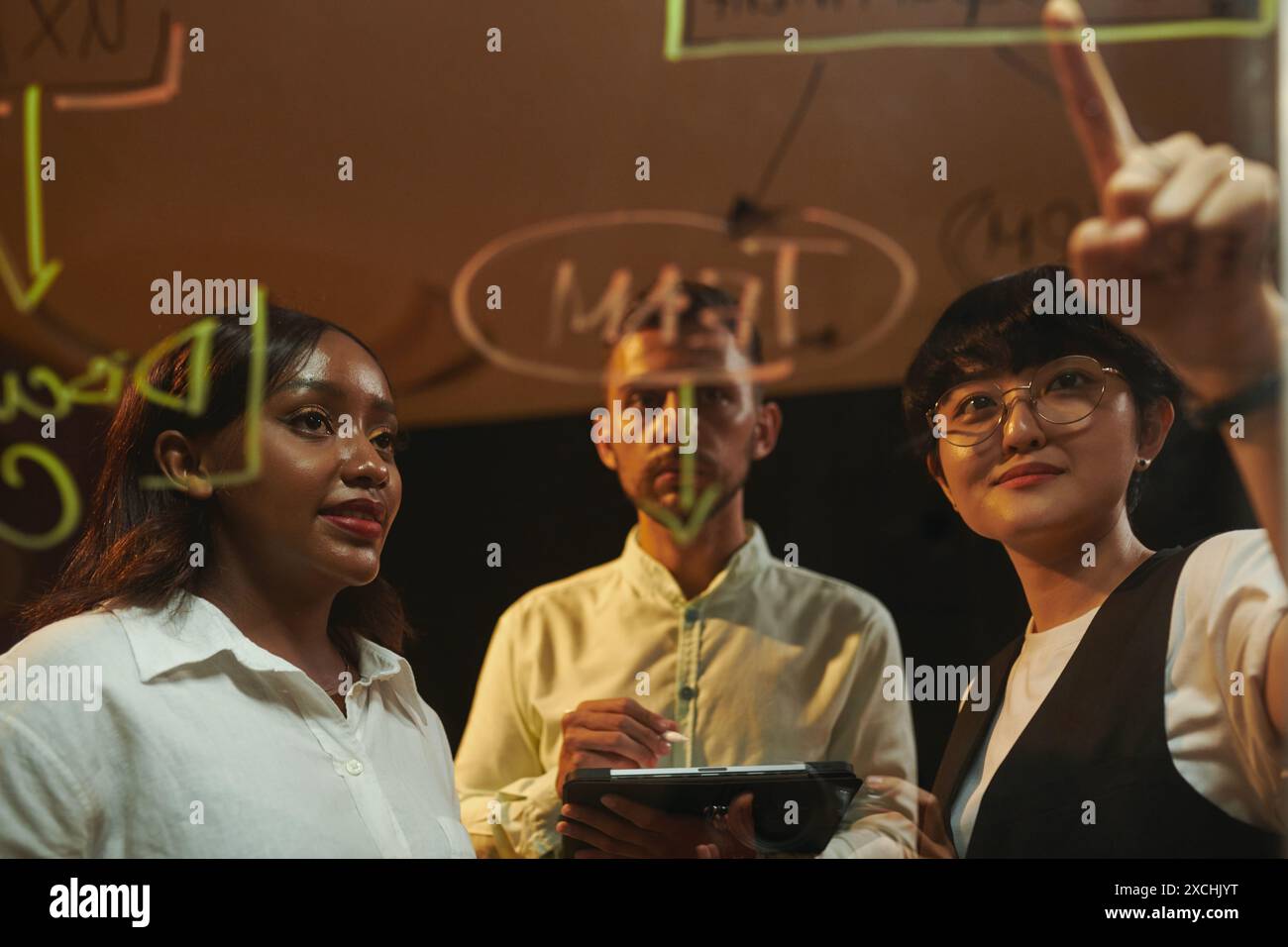 Positive business team drawing chart on transparent wall Stock Photo ...