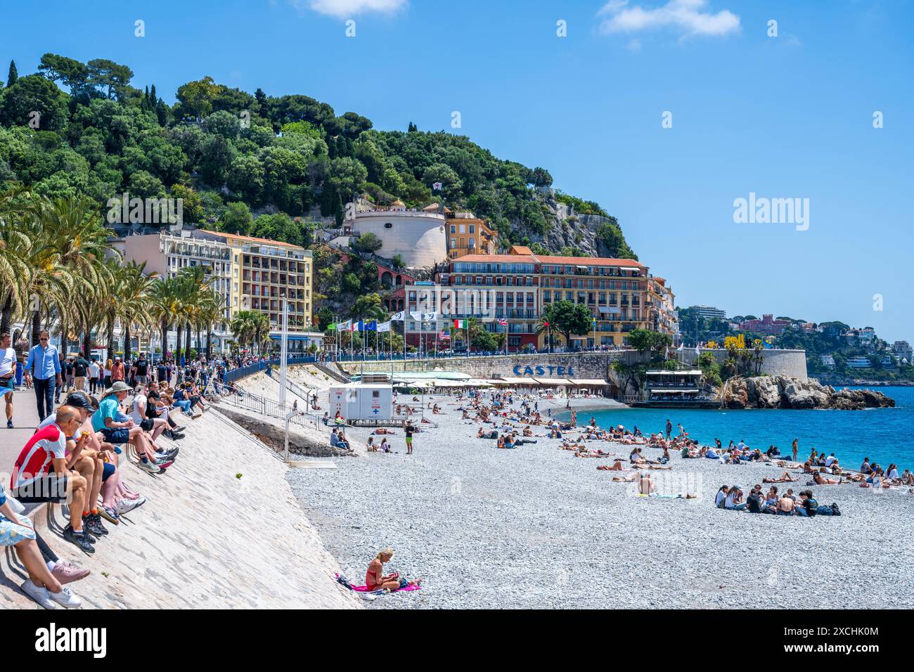 Sunbathers on Plage des Ponchettes (public beach) with Tour Bellanda in ...