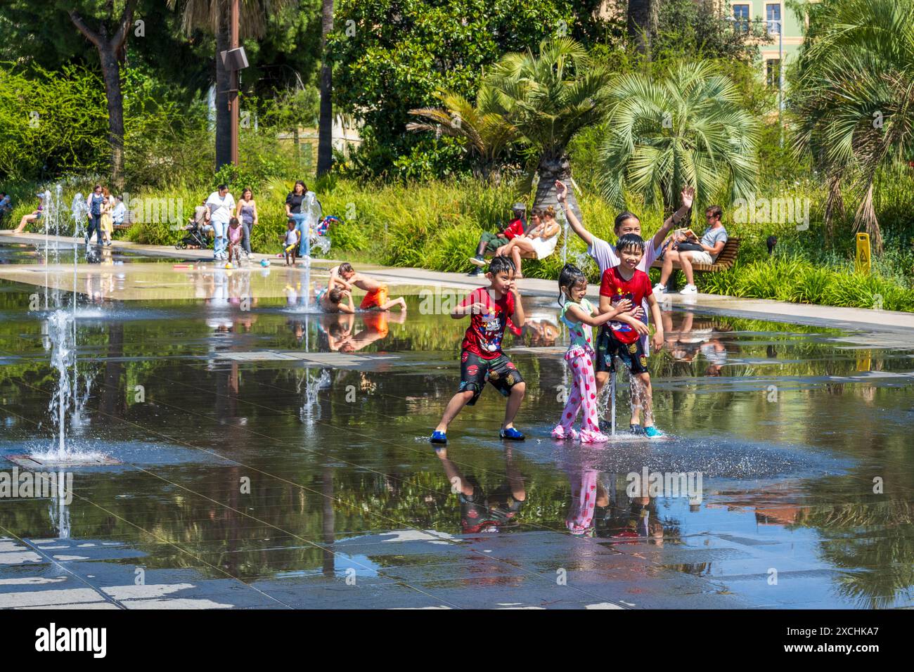 Fun in the water jets Fontaine Miroir d’Eau on Promenade du Paillon in ...