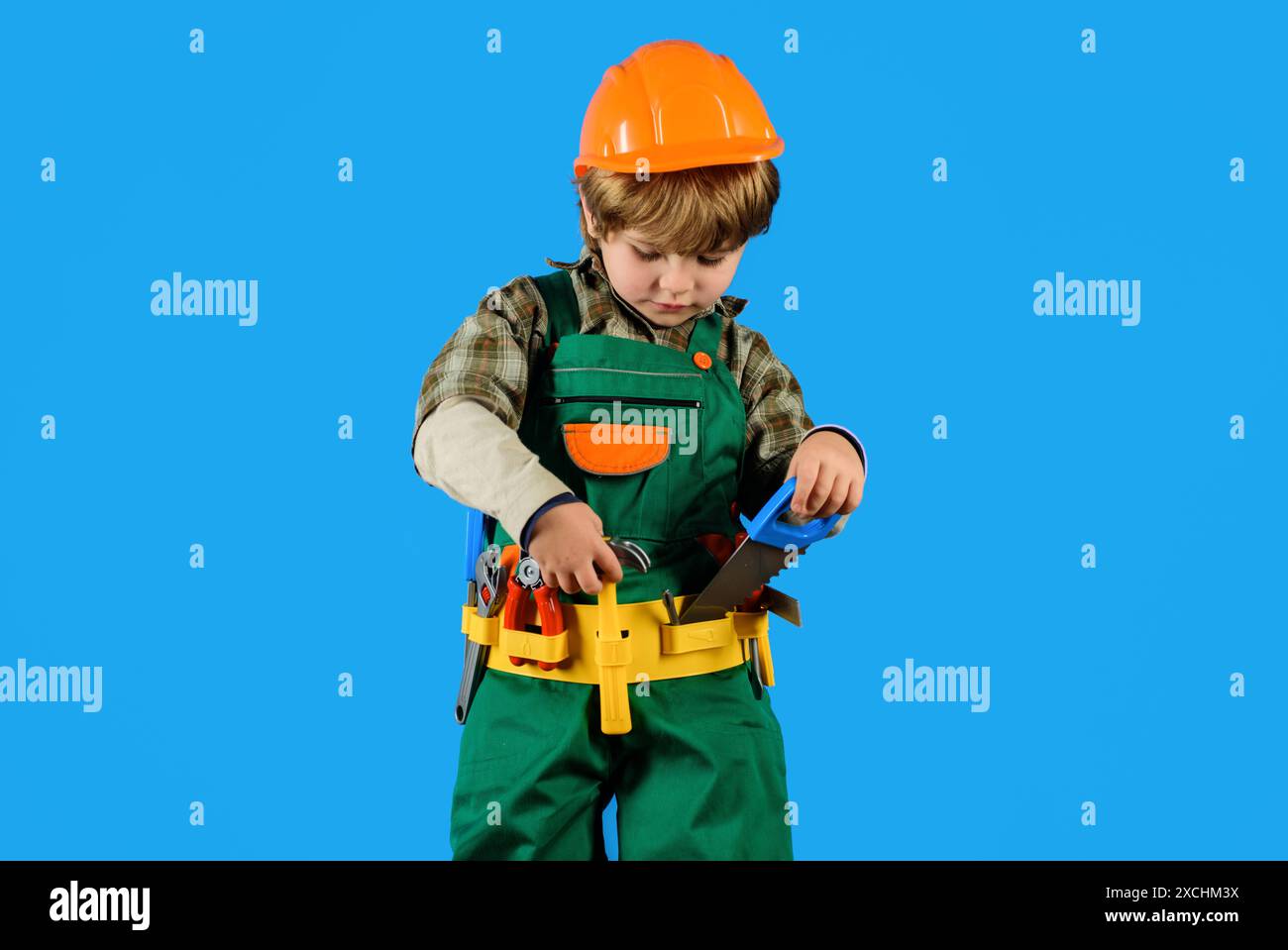 Little boy in hard hat and builder's uniform with tool belt. Little ...