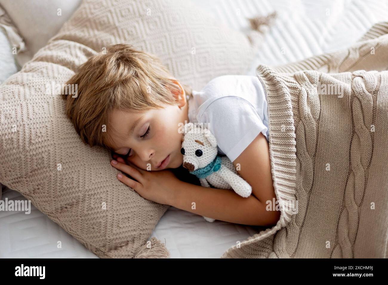 Sweet little child, boy sleeping in bed with teddy bear in the ...