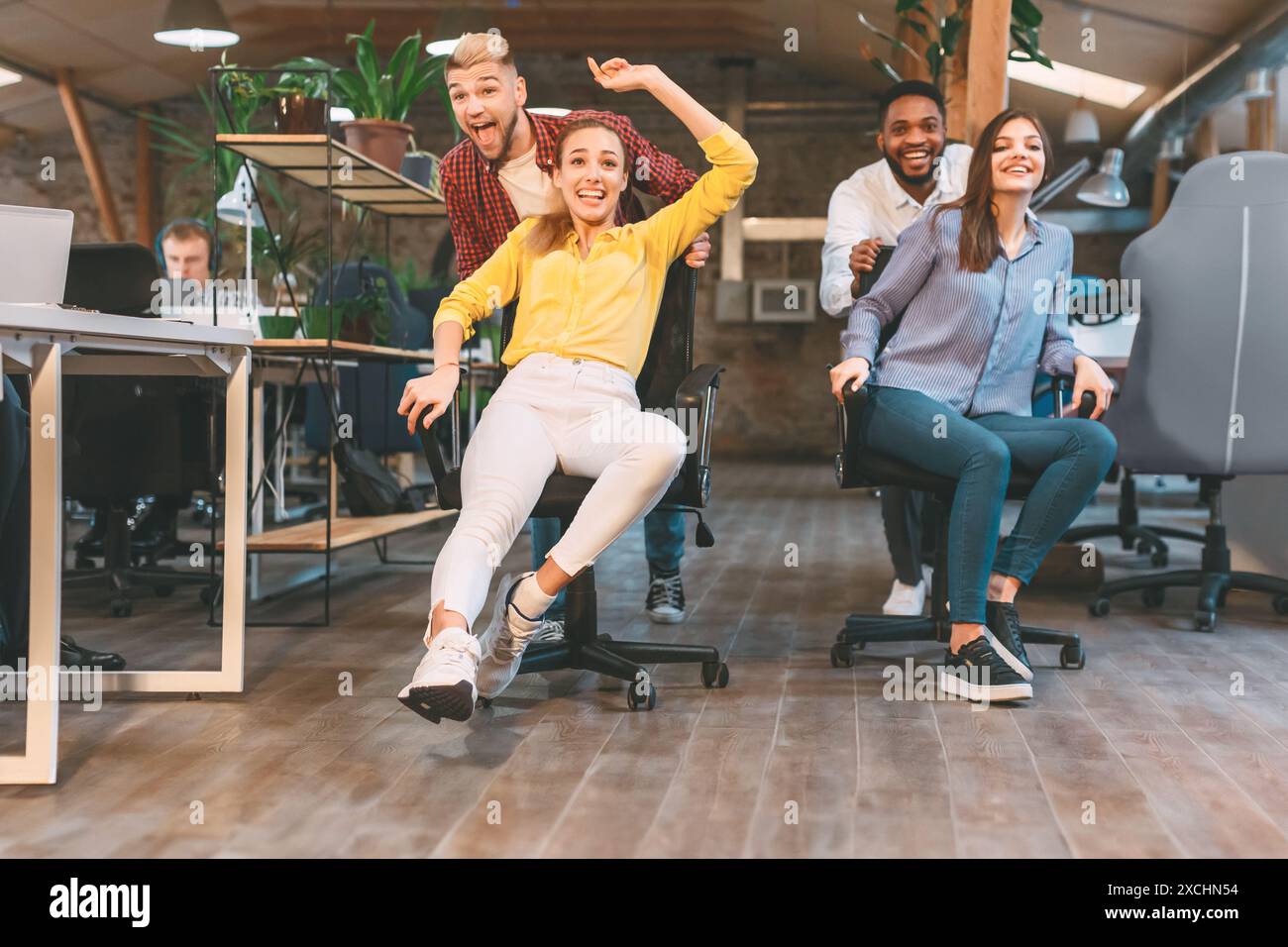 Time for break. Joyful colleagues having fun at workplace Stock Photo ...